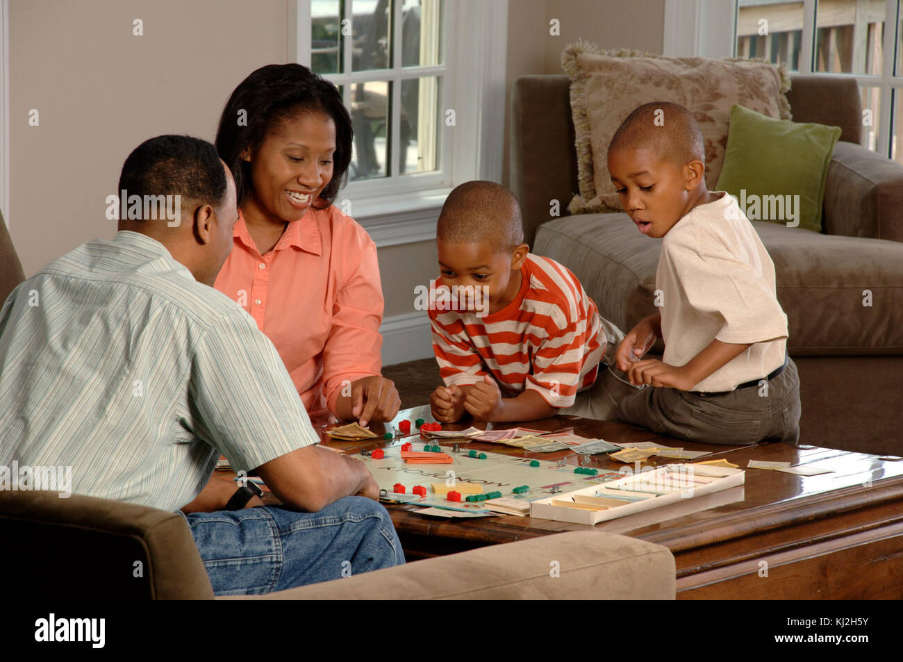 Family playing board game Stock Photo - Alamy