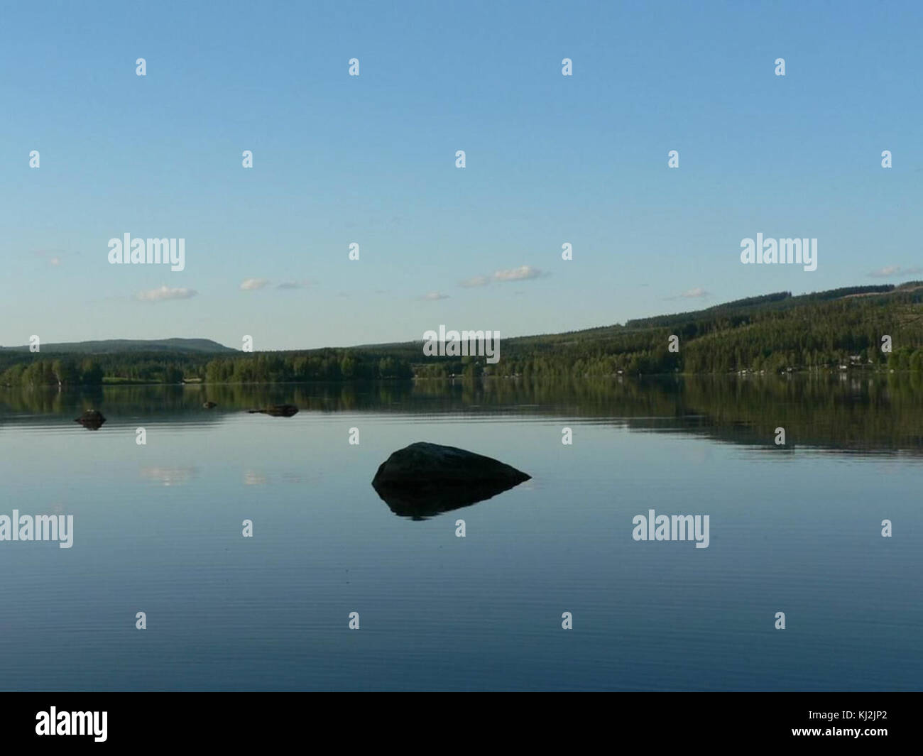 Mirror lake with stone in water Stock Photo - Alamy