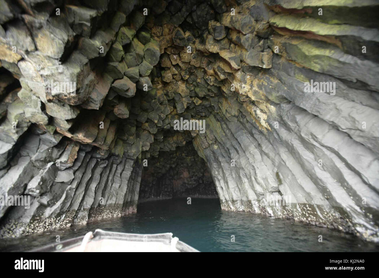 This image shows the entrance of a basalt cave, featuring the unique ...