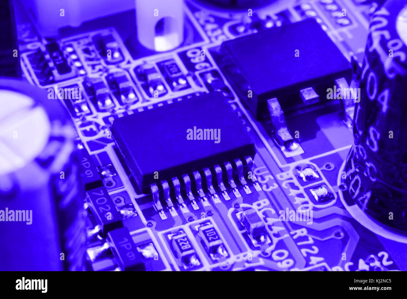 Integrated semiconductor microchip on blue circuit board representative ...