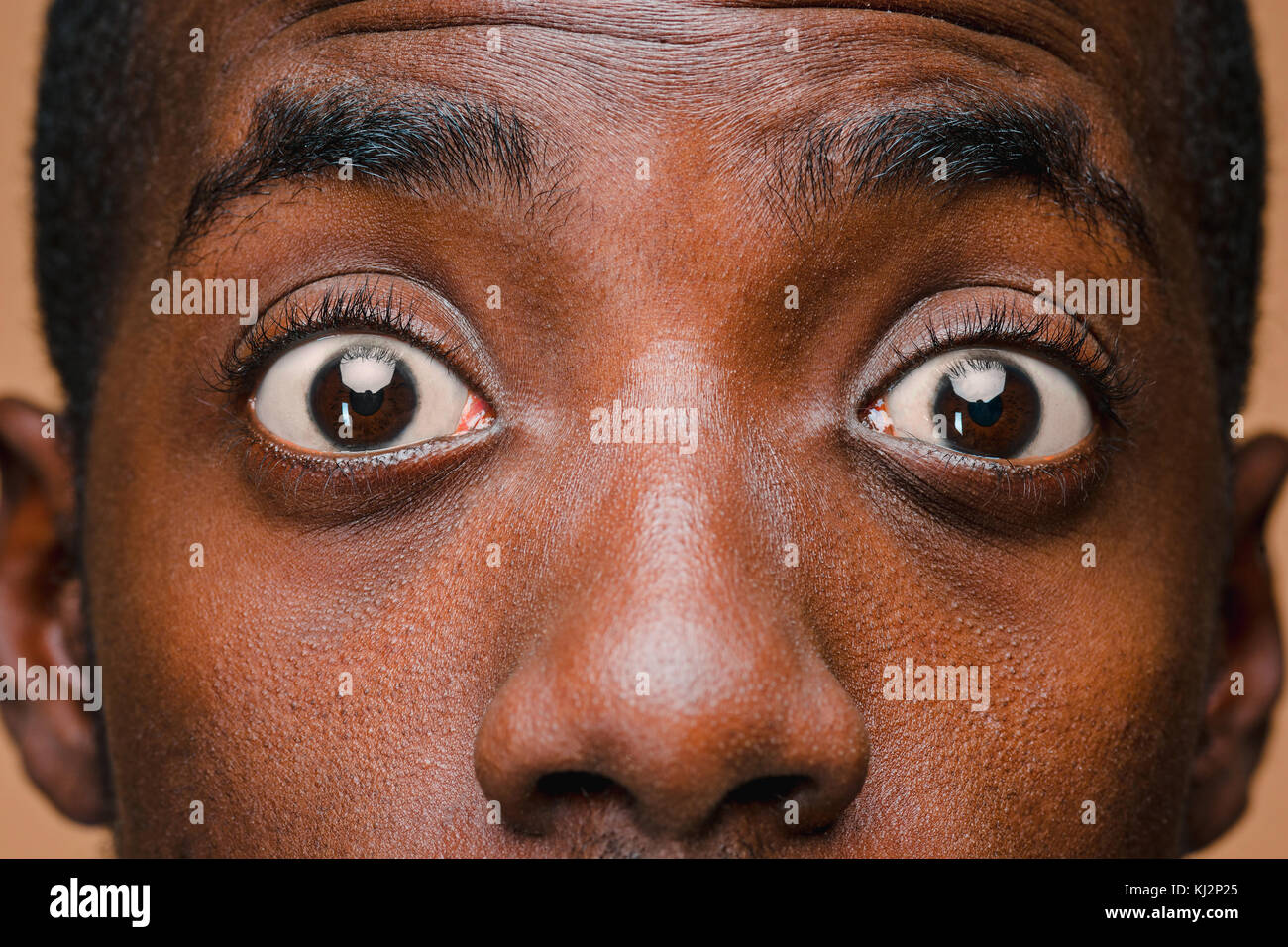 The portrait of handsome young surprised black african man Stock Photo ...