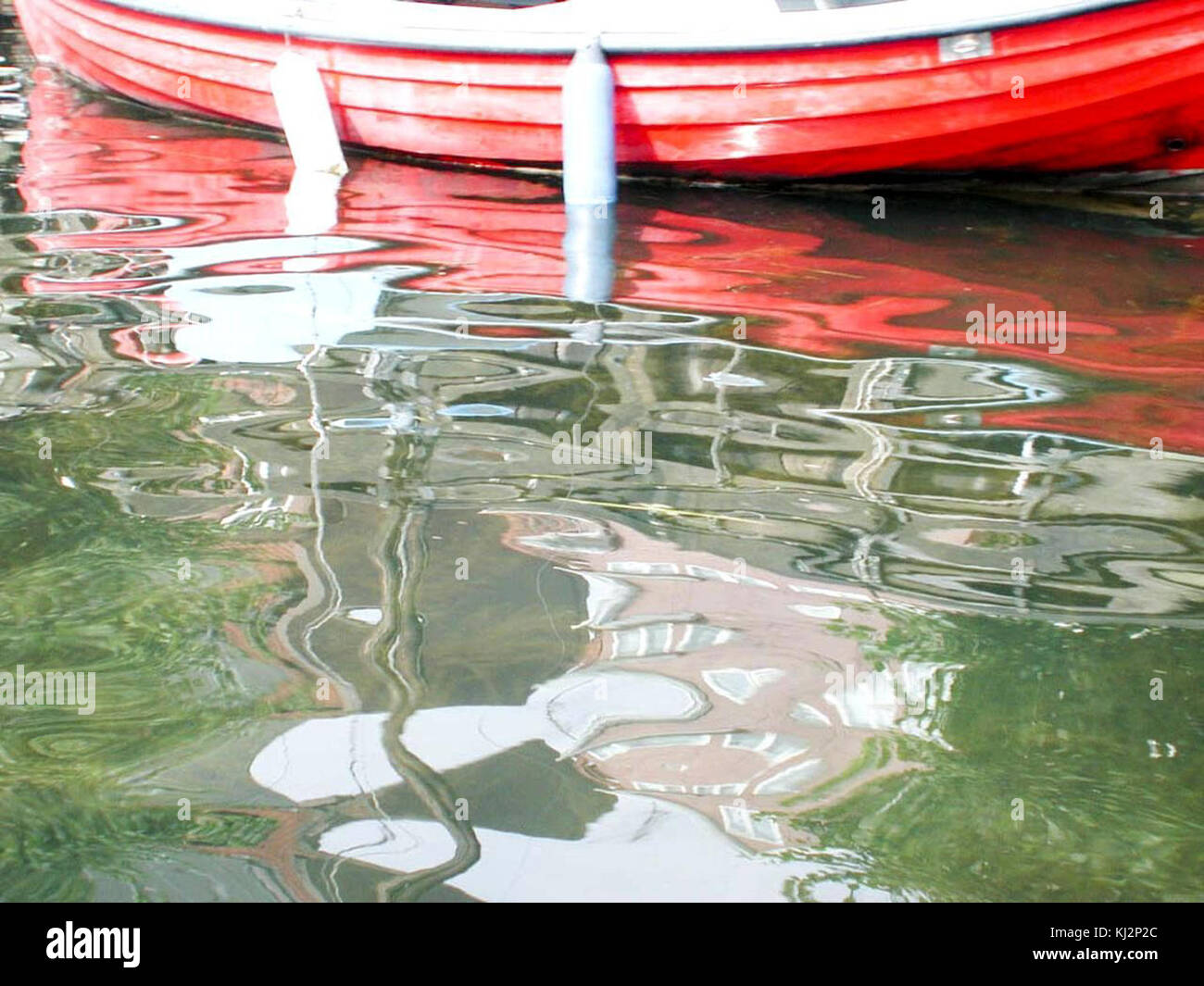 Small boat water reflection Stock Photo - Alamy