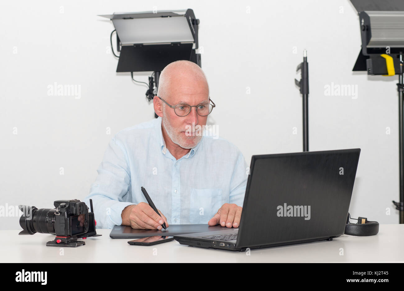 a man working on his graphics tablet and laptop Stock Photo - Alamy