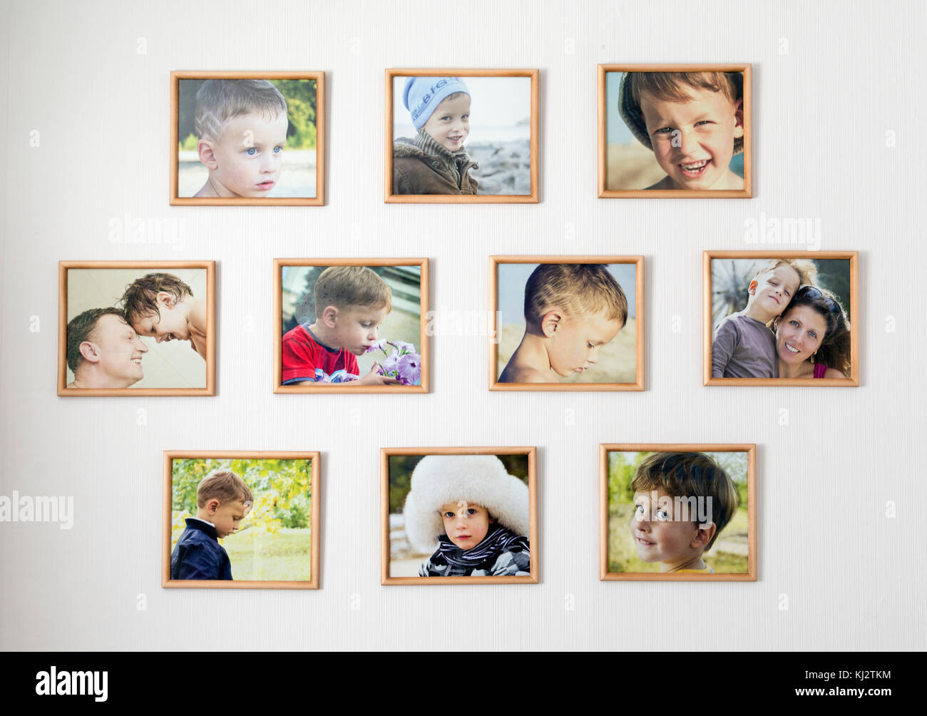 white wall with photos of the family in wooden photo frames Stock Photo ...
