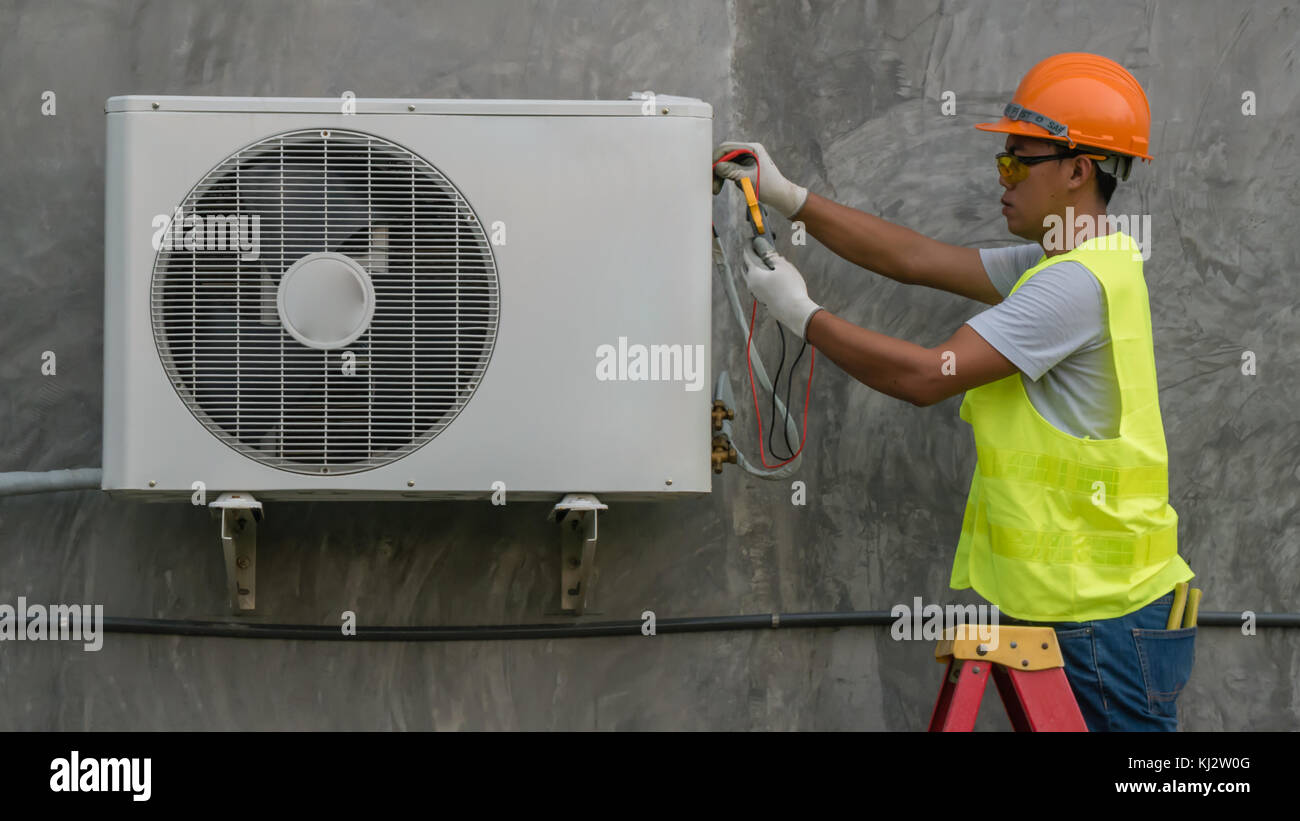 Technician is checking outdoor air conditioner unit Stock Photo - Alamy