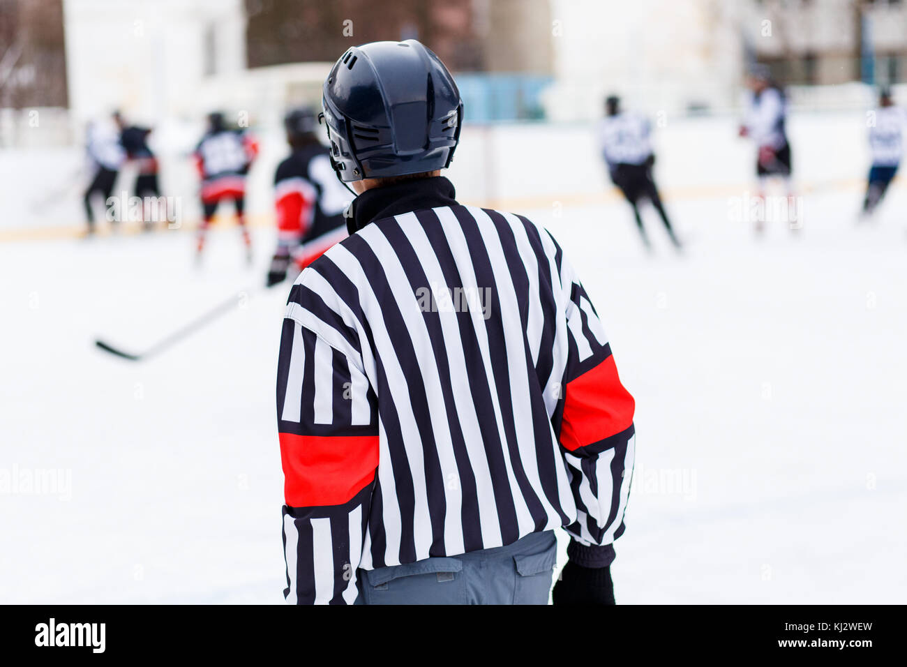Referee on rink on ice hockey game Stock Photo - Alamy