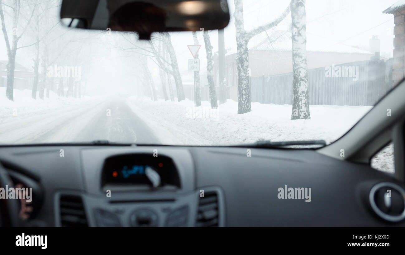 Bad weather driving in winter. Blizzard and fog on the road with low ...