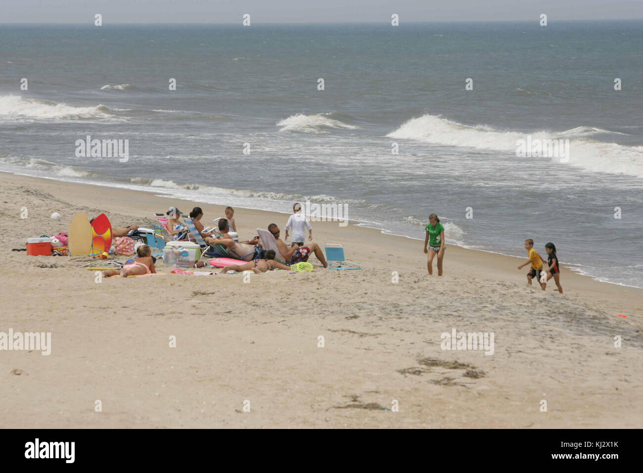 Beachgoers enjoy outing at the beach Stock Photo - Alamy