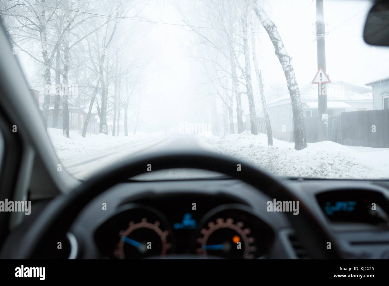 Bad weather driving with low visibility in winter. Thick fog on the ...