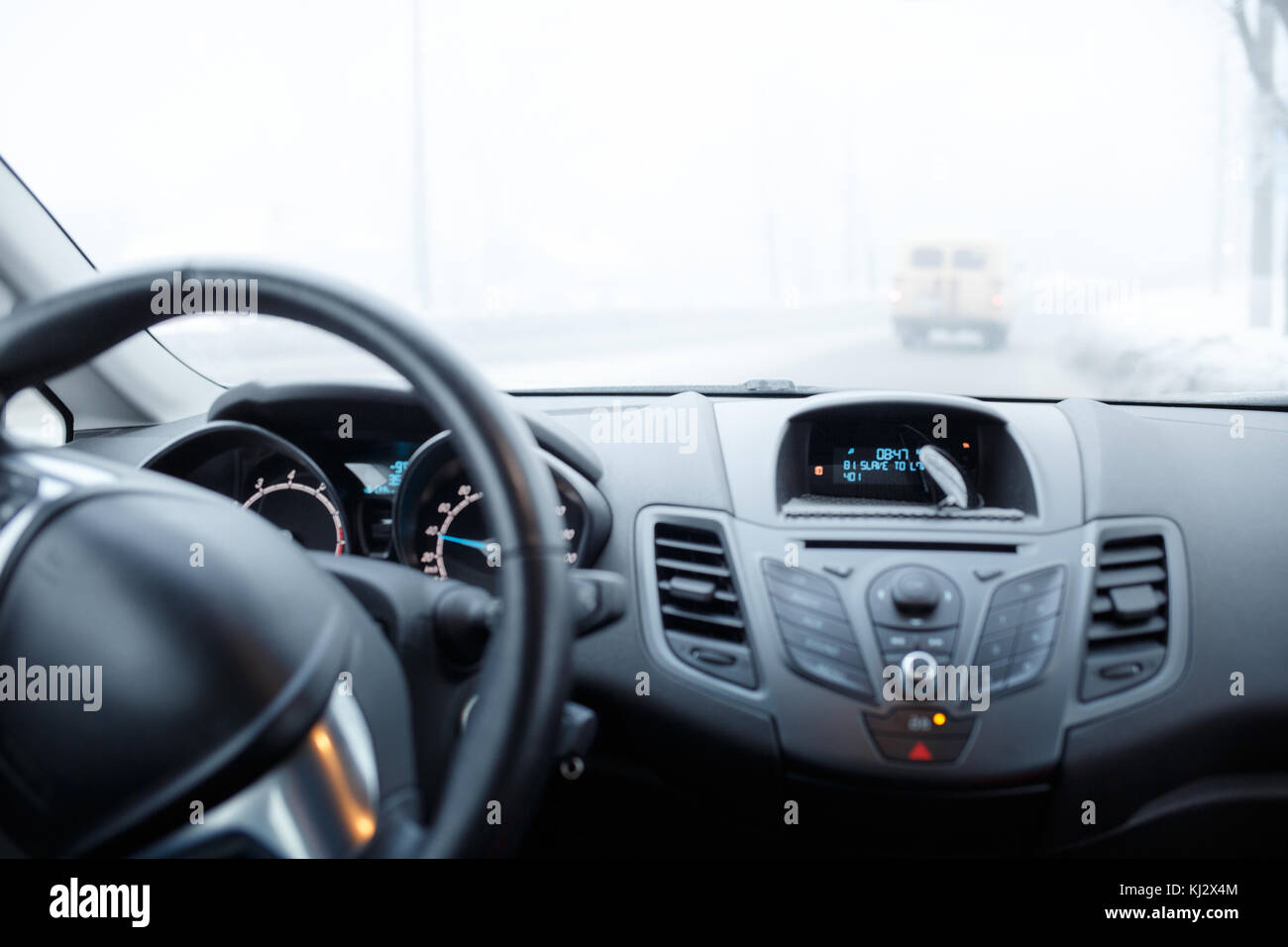 Bad weather driving in winter. Blizzard and fog on the road with low ...