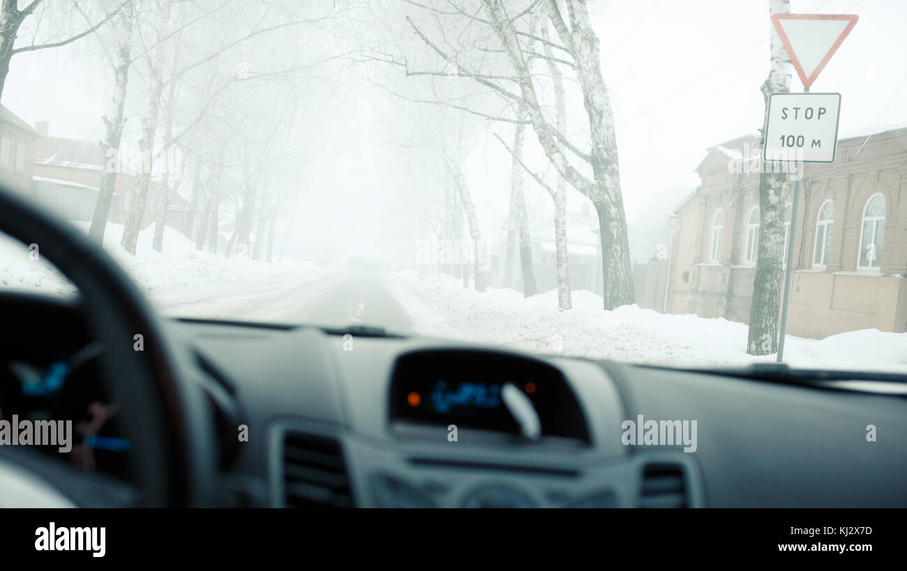 Bad weather driving with low visibility in winter. Thick fog on the ...