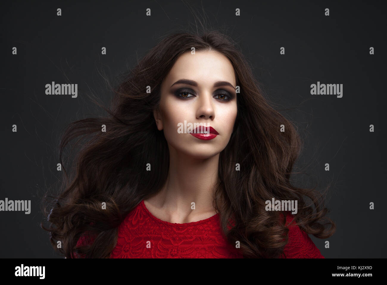 Portrait of the beautiful young woman with long brown hair posing at ...