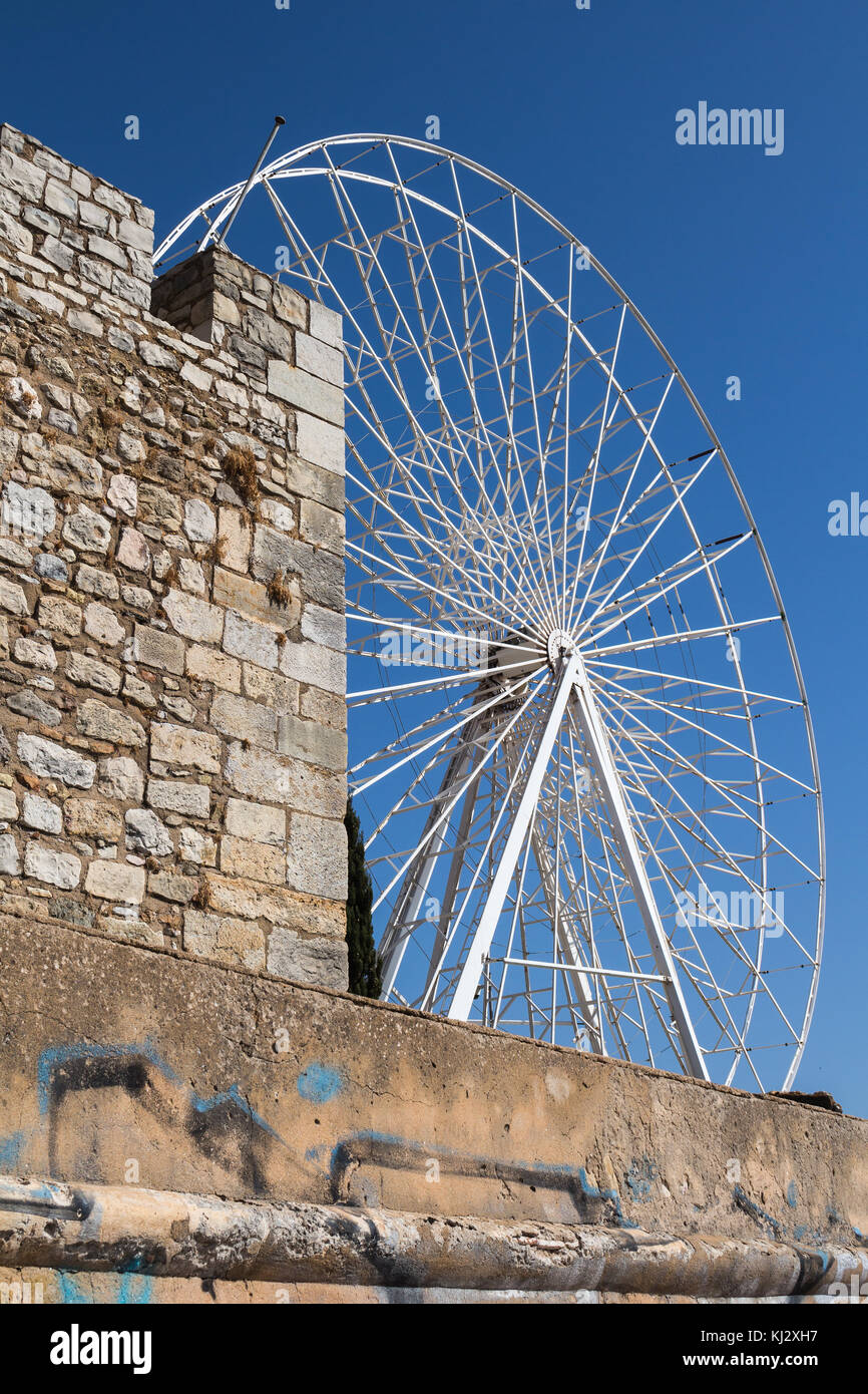 Wall of the old fortification made of stones and a bright white ...