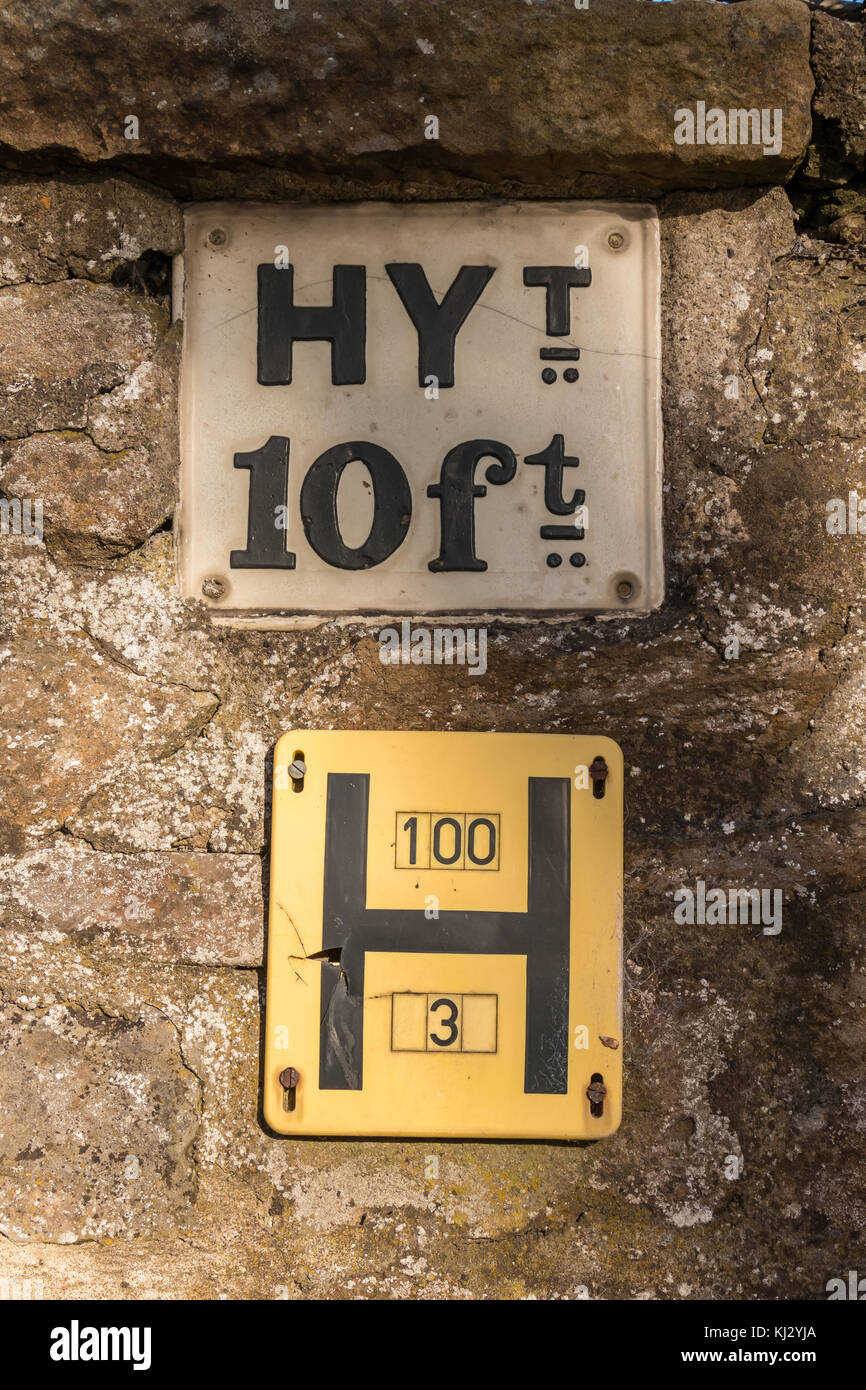 Old original and modern day replacement fire hydrant signs on a wall in ...