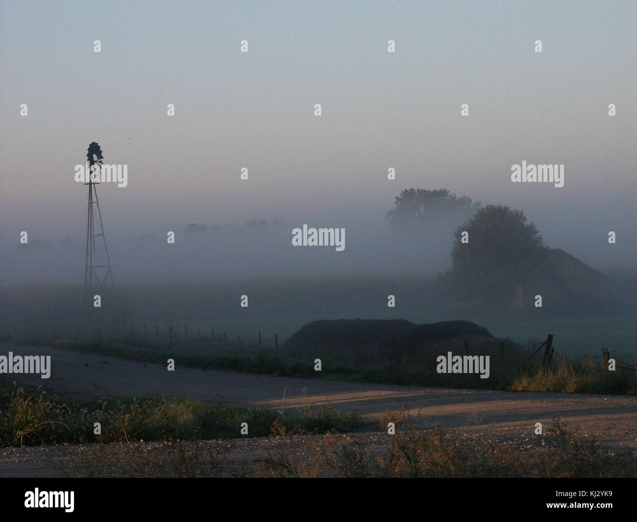 Iowa windmill in the early morning fog Stock Photo - Alamy