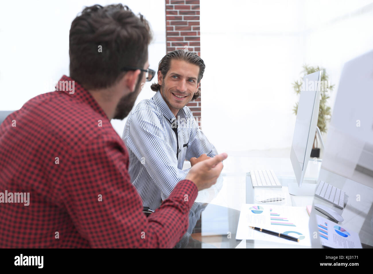 employees sitting behind a Desk Stock Photo - Alamy