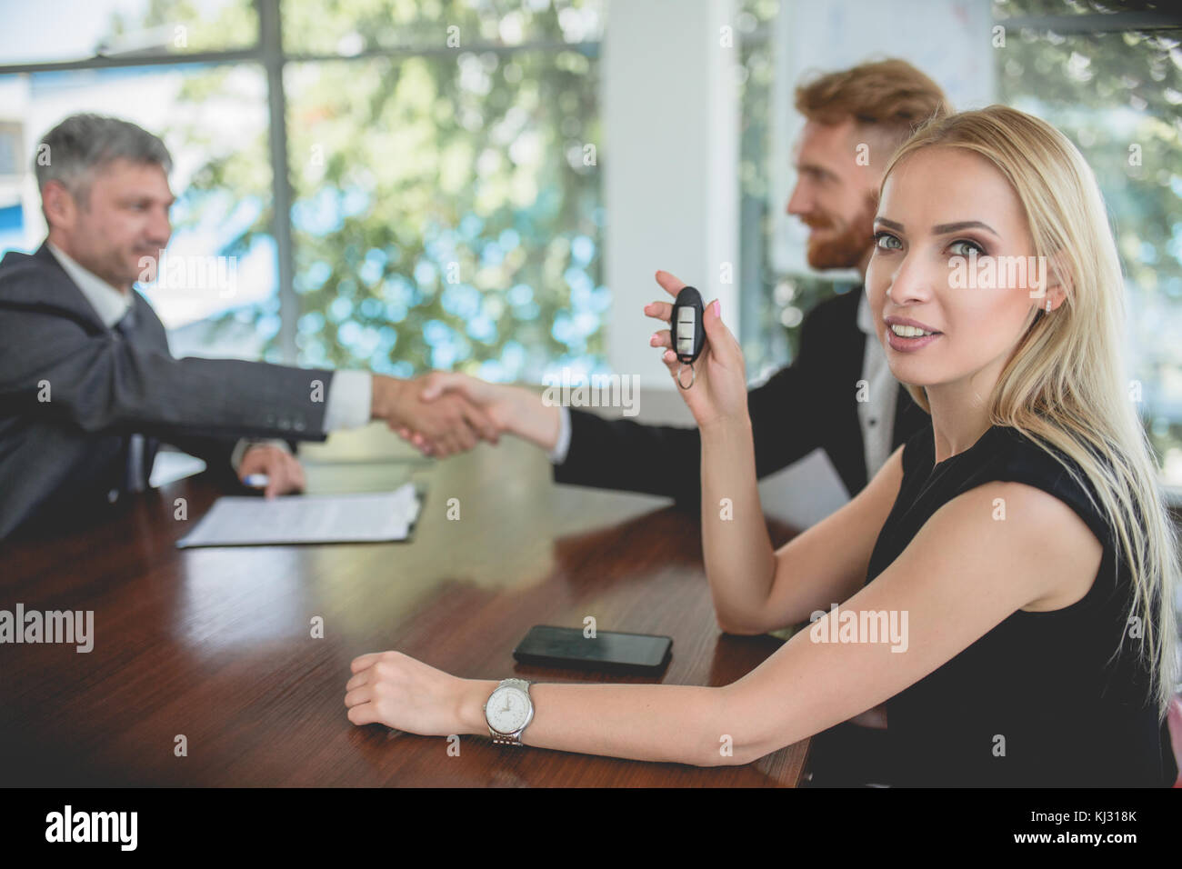 Happy young woman holding key from new car Stock Photo - Alamy