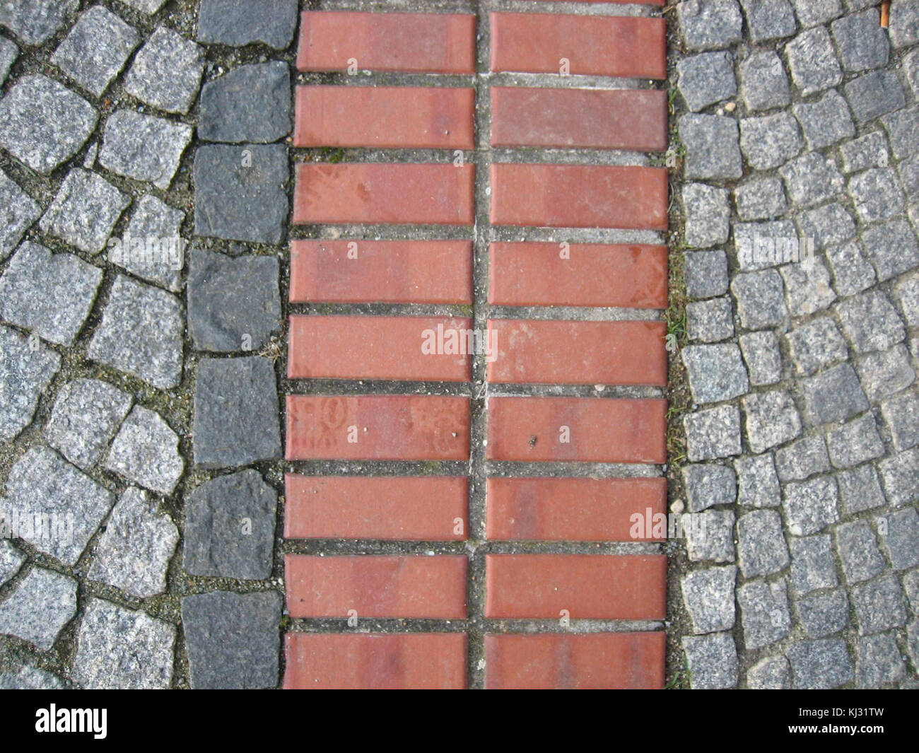 The image or reference shows paving stones and red bricks, likely from ...