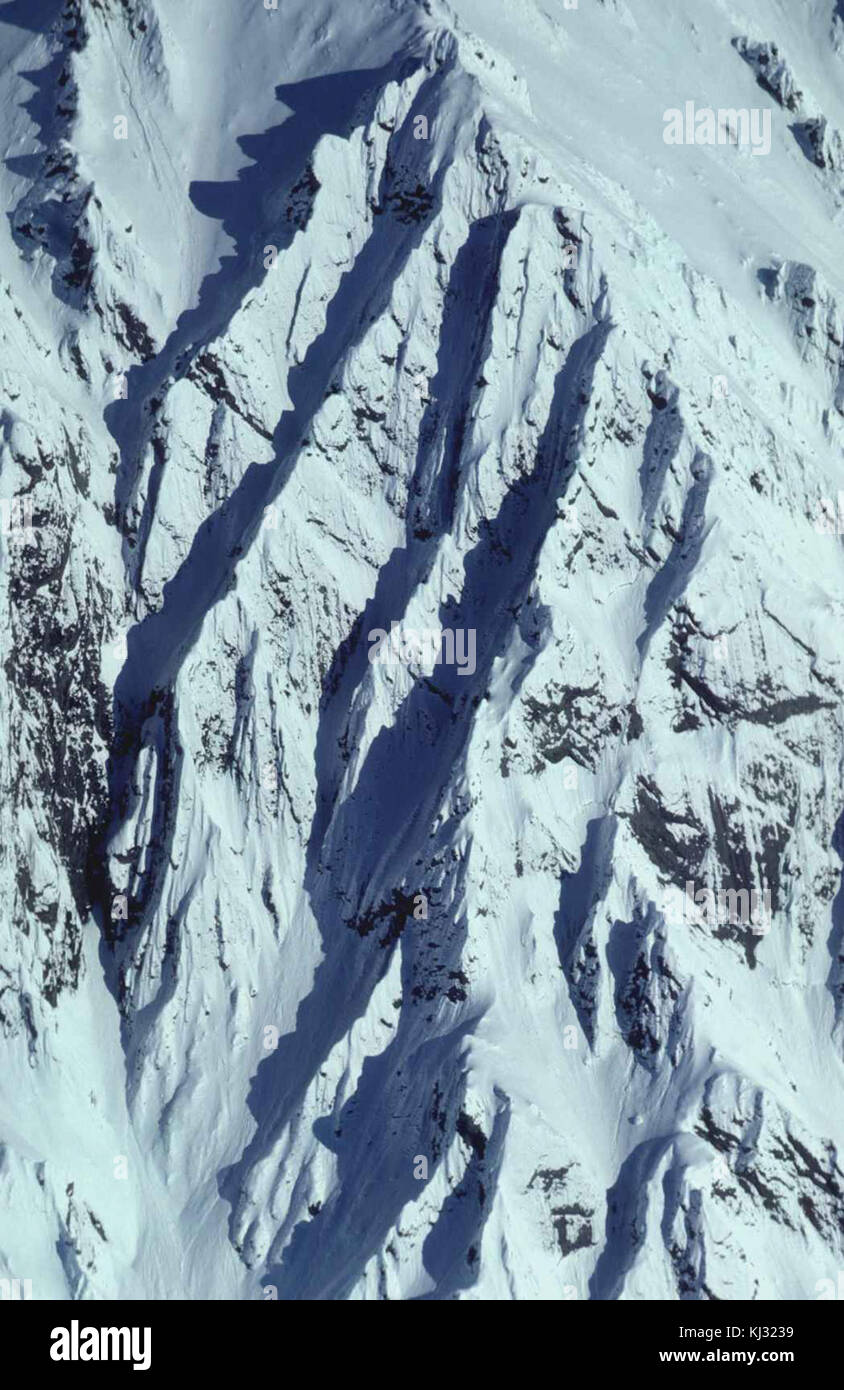Snow covered mountain cliffs Stock Photo - Alamy