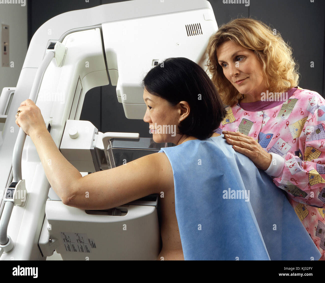 This image shows a woman undergoing a mammogram, an essential ...