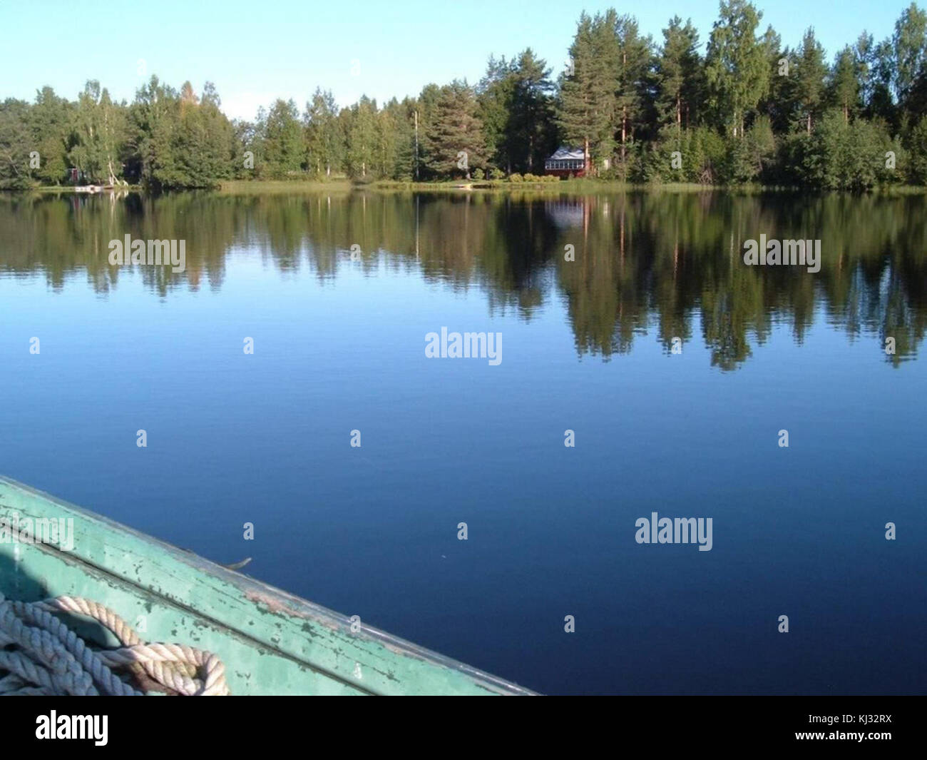 Rowing boat on still lake Stock Photo - Alamy