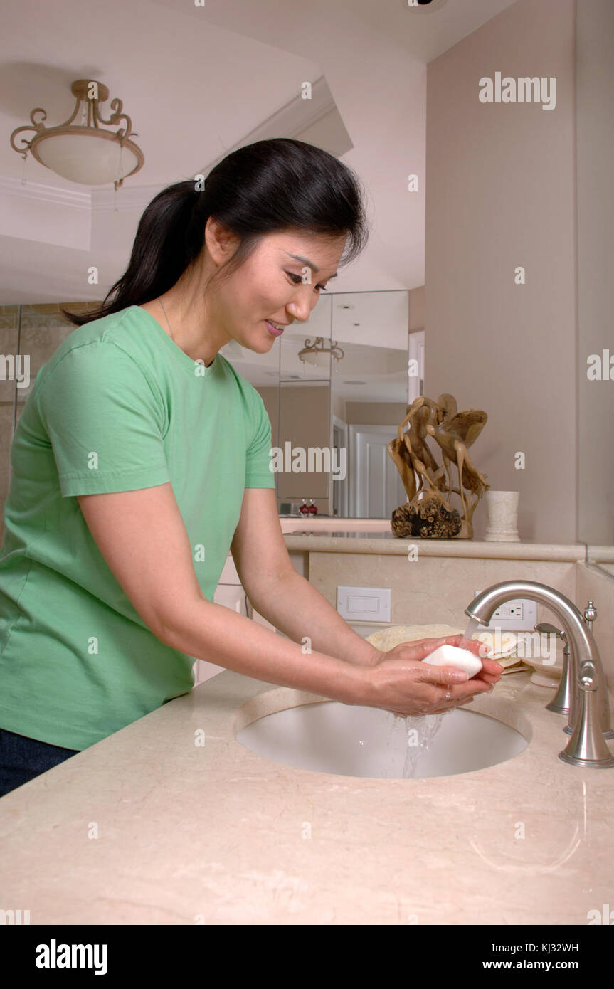 Woman washing hands Stock Photo - Alamy