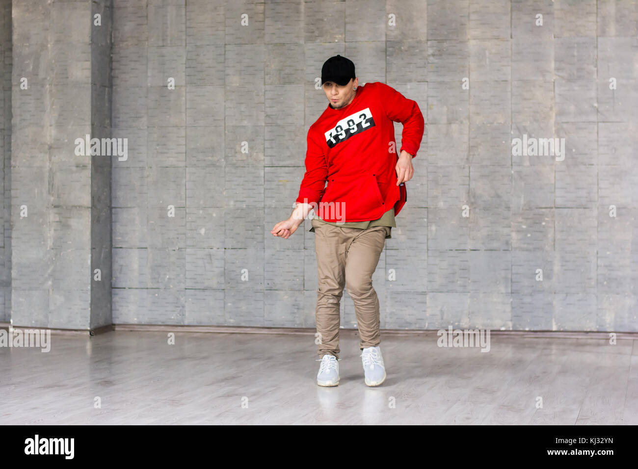 Young rapper dance on grey background Stock Photo - Alamy