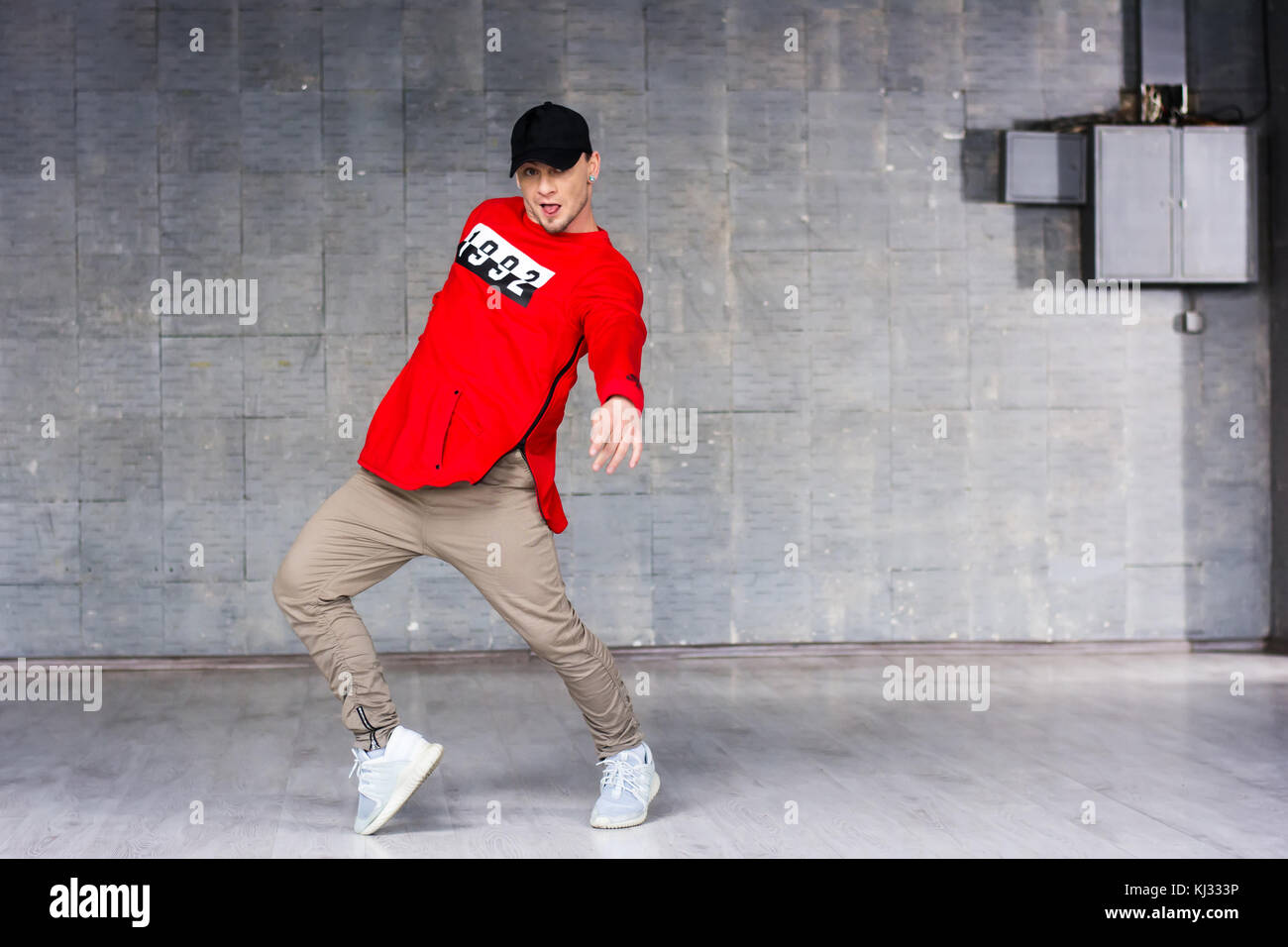 Young freestyle dancer on grey background Stock Photo - Alamy