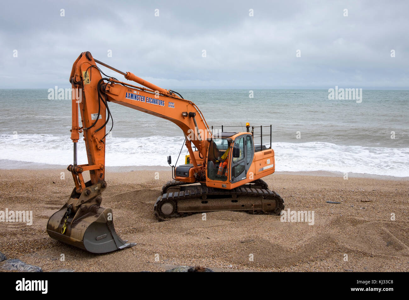 Large excavator helping in rebuilding sea defences on Slapton Sands at ...