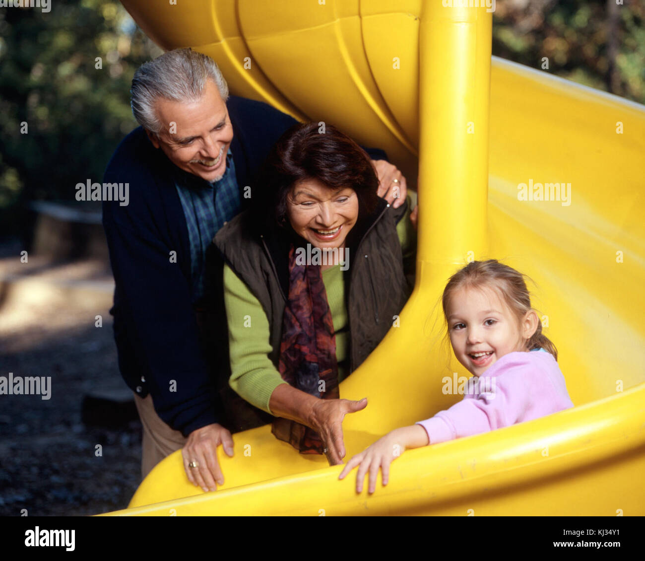 Family at a playground Stock Photo - Alamy