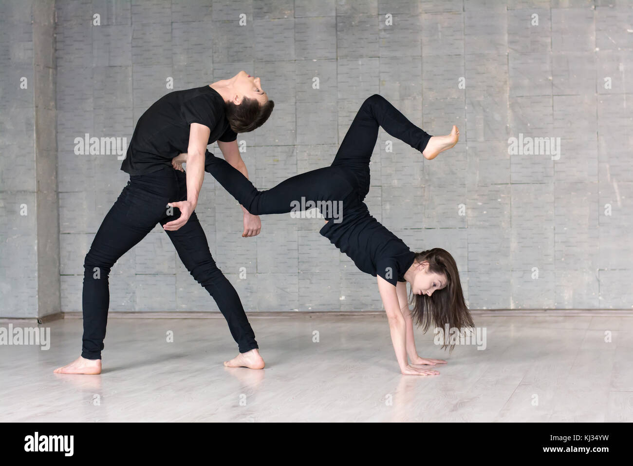 Young couple make acrobatic element Stock Photo - Alamy
