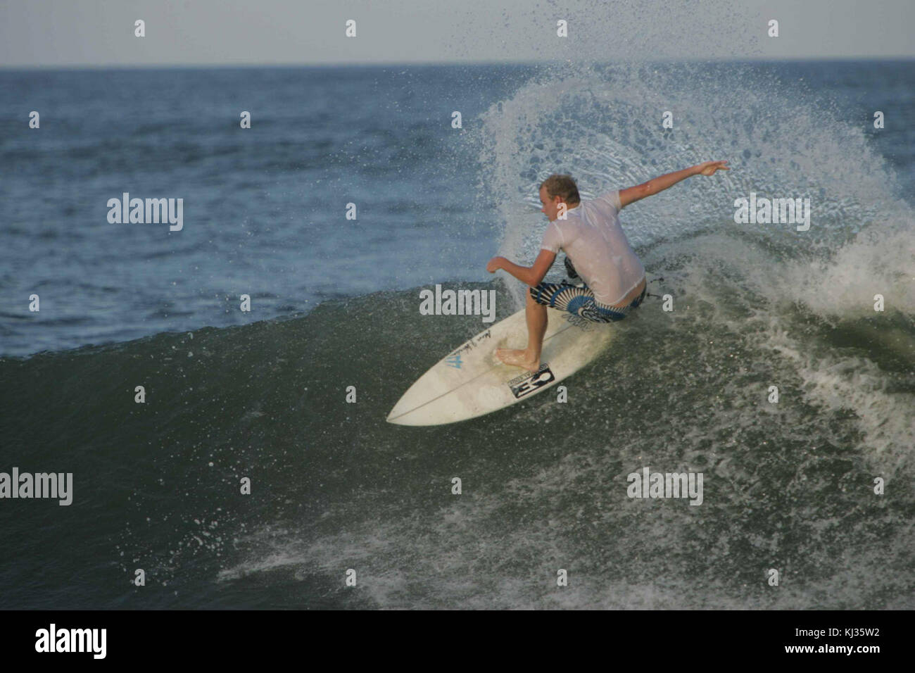 Surfer maneuvers a front side cutback to generate more speed on a wave ...