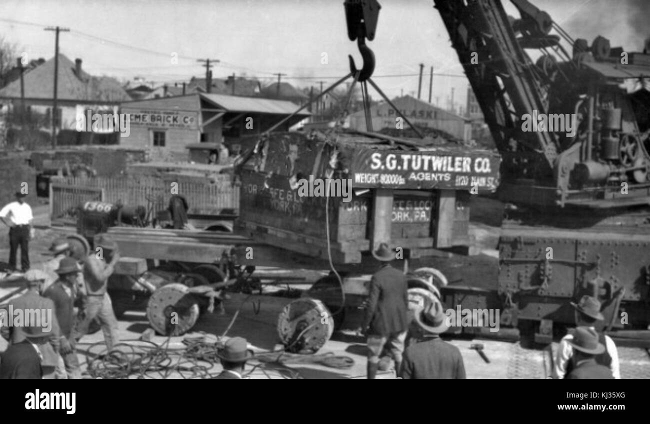 Crane lifting vault door 1920s Stock Photo - Alamy