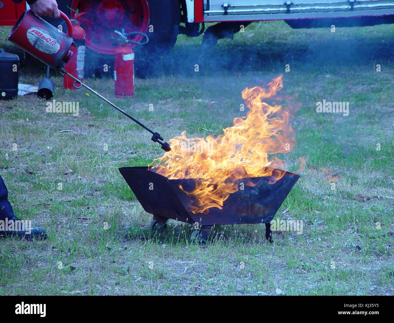Fireman lighting a brazier Stock Photo - Alamy