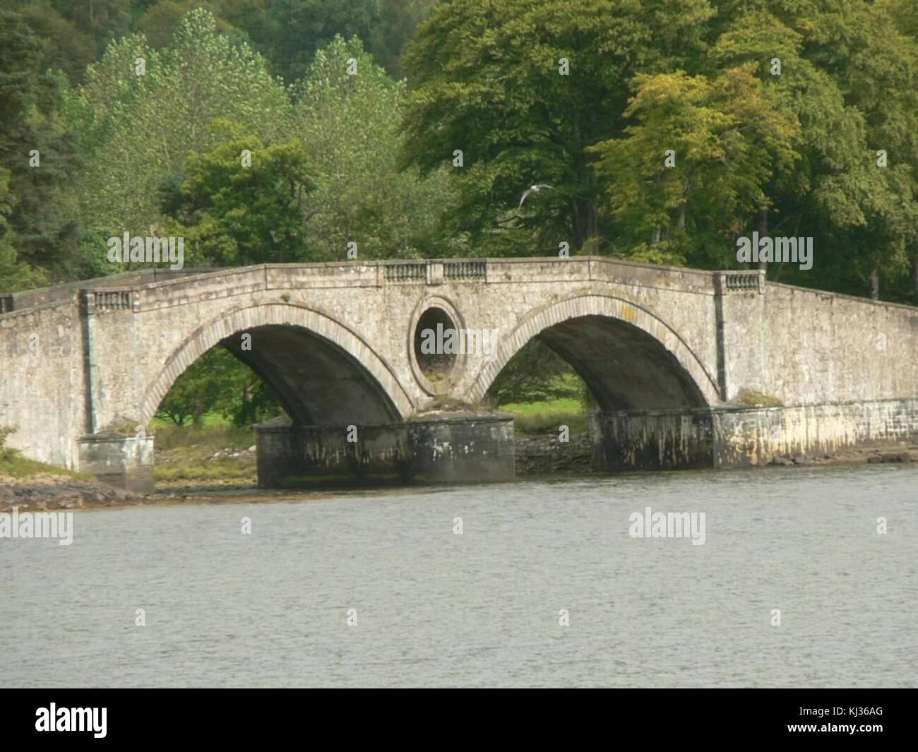 Old bridge on lake Stock Photo - Alamy