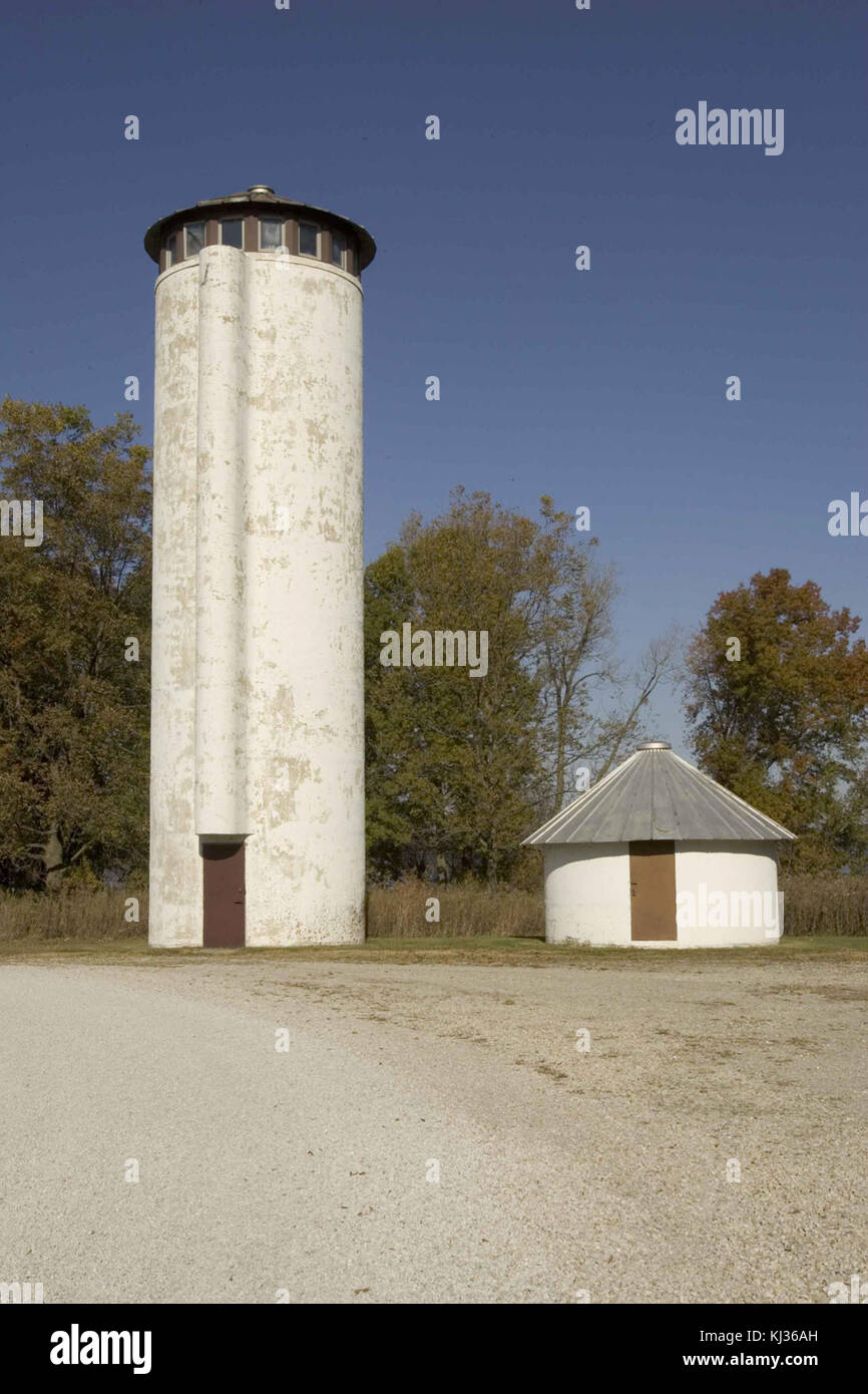 Tall white silo shaped wildlife observation tower with viewing spaces ...