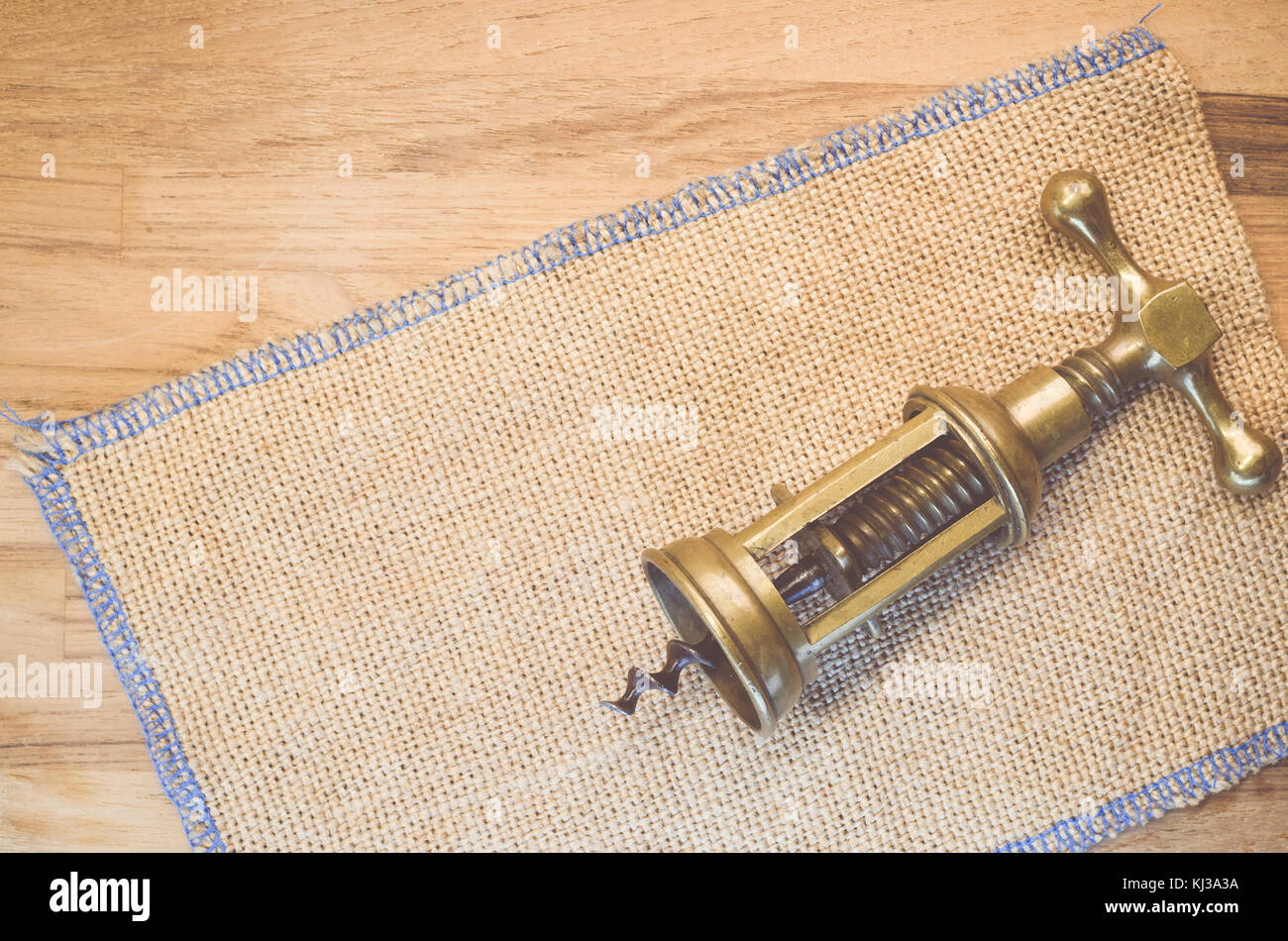 vintage hand made solid brass corkscrew on a natural wood and burlap ...