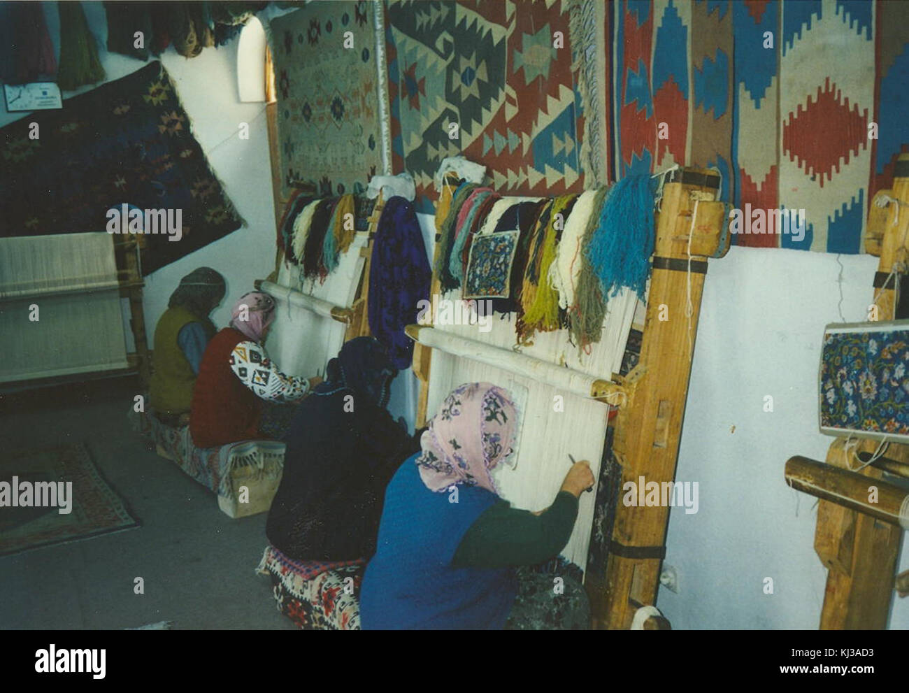 A traditional craft of weaving Turkish carpets, emphasizing the ...