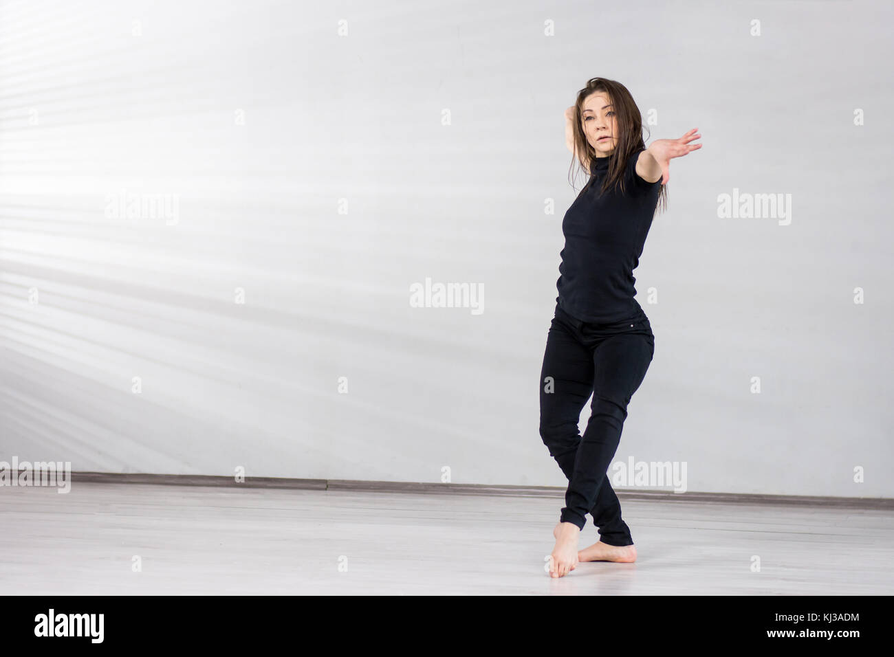 Slim dancing woman on studio background Stock Photo - Alamy