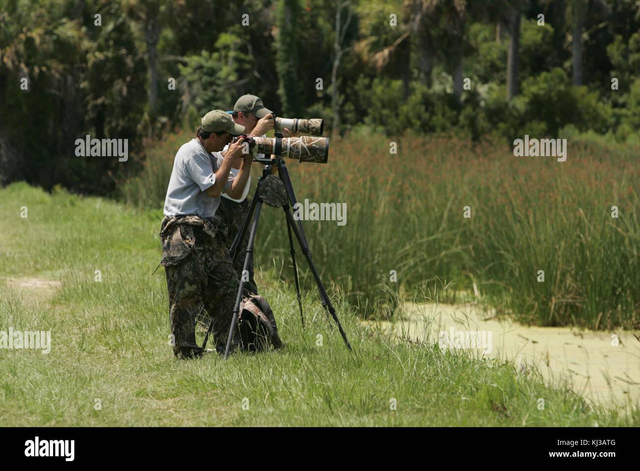 This photograph shows two professional photographers equipped with ...