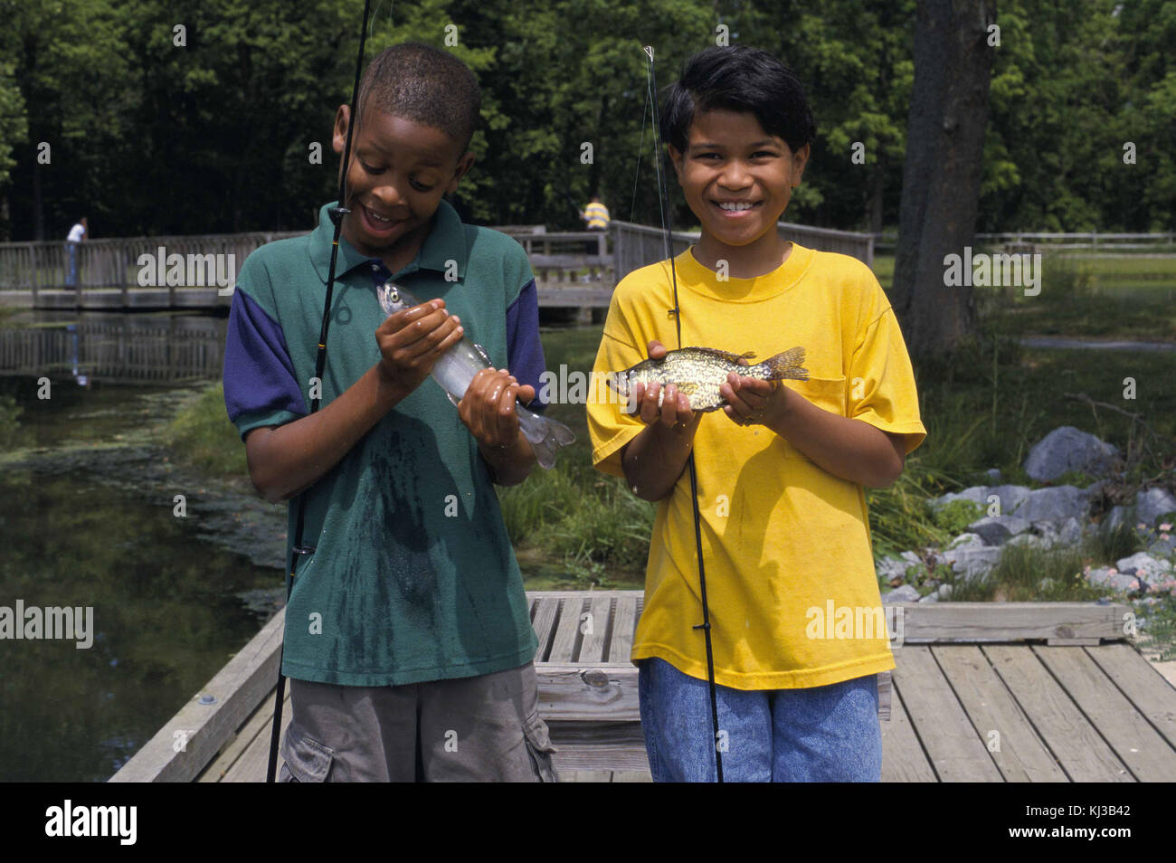 Two young boys show off their catched fish Stock Photo - Alamy