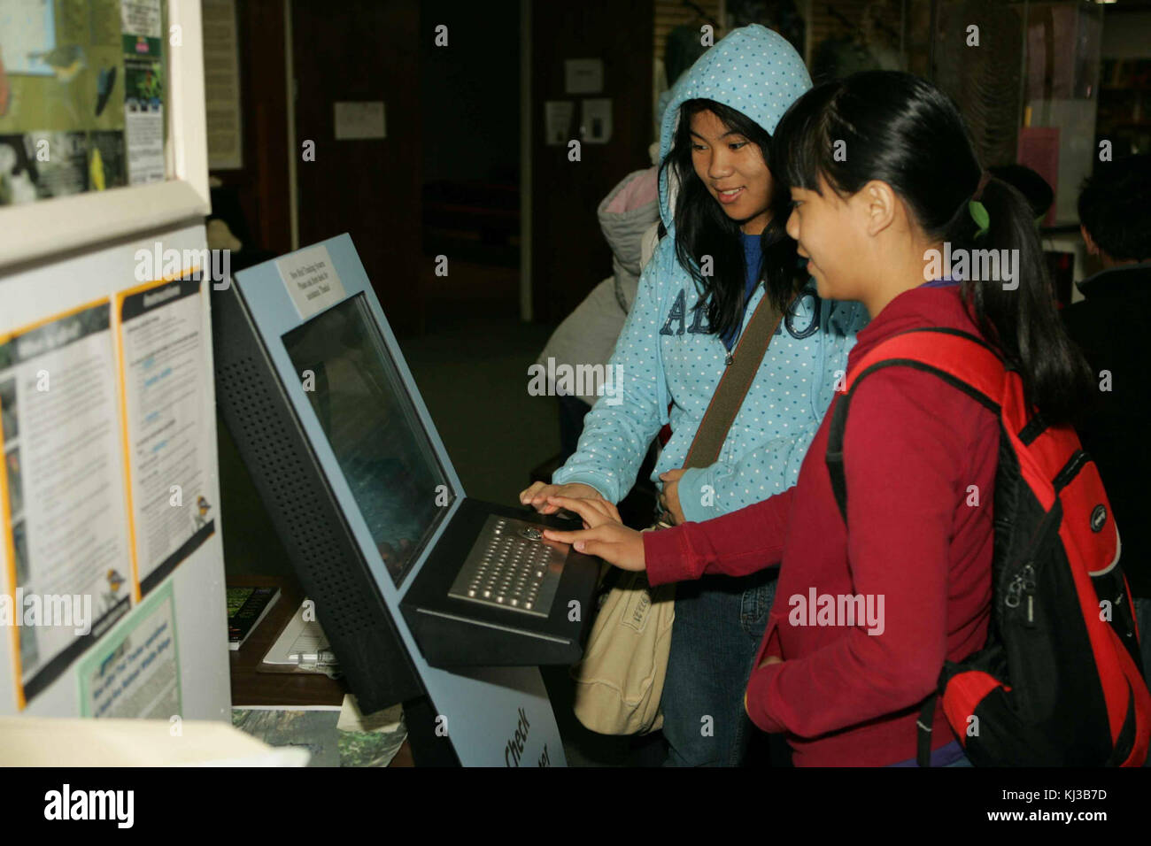 Two young women embracing new technology enjoy using computer Stock ...