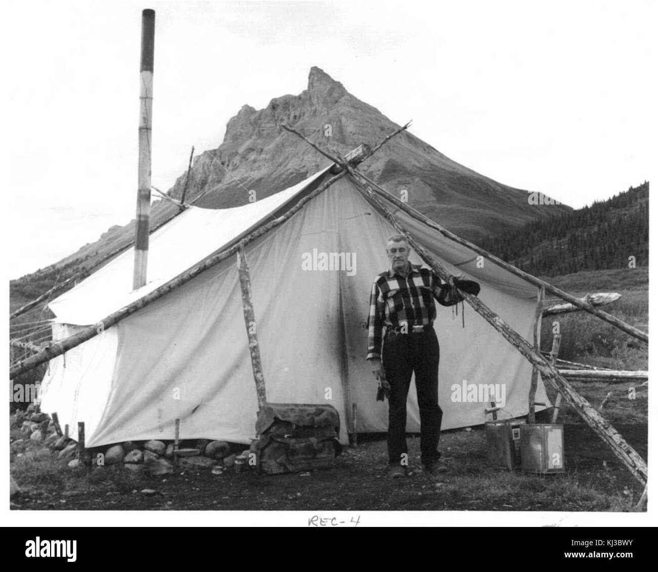 An image of a man in a valley setting, possibly with a wall tent ...