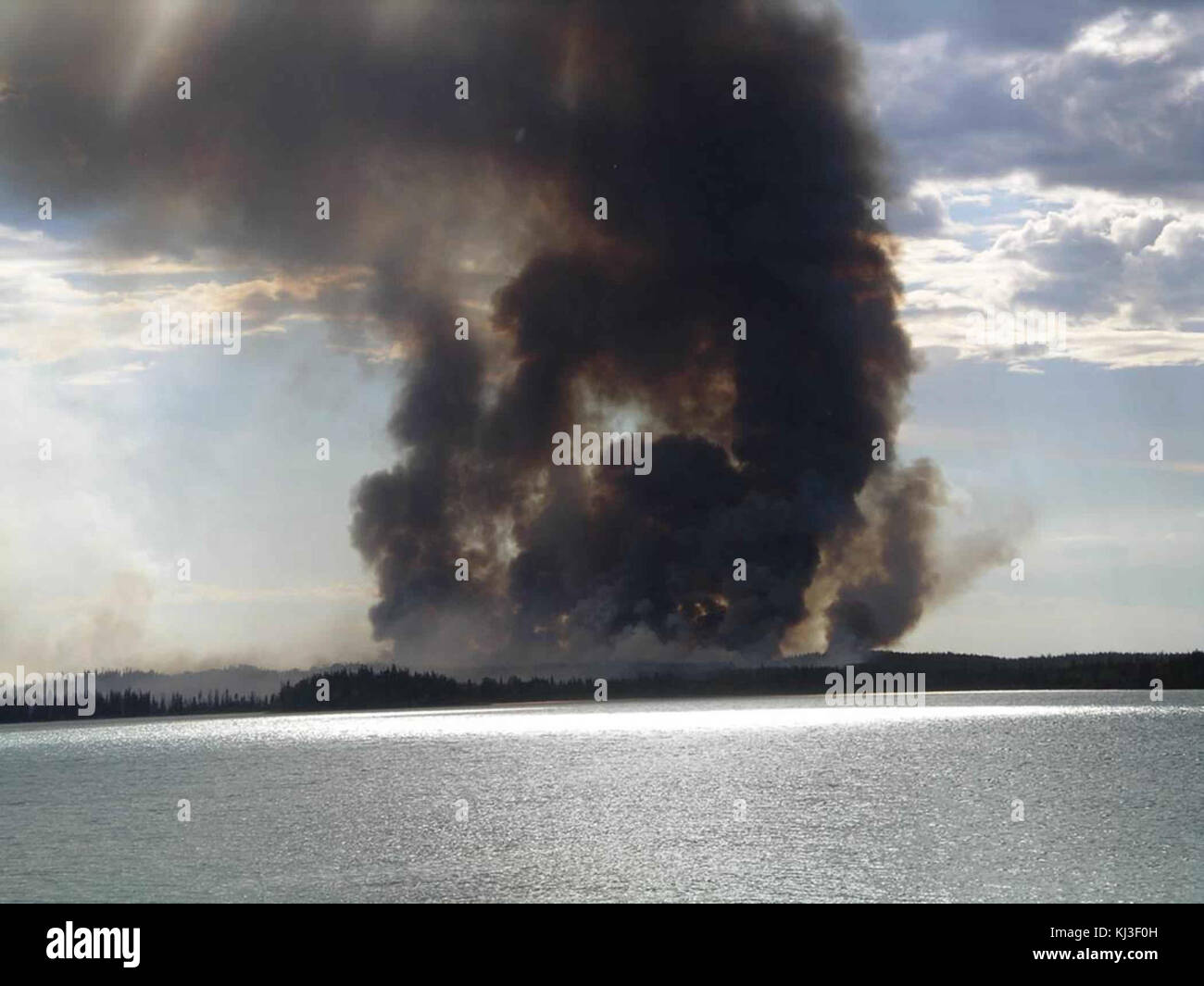 Watching big black smoke fire rising from huge forest fire Stock Photo ...