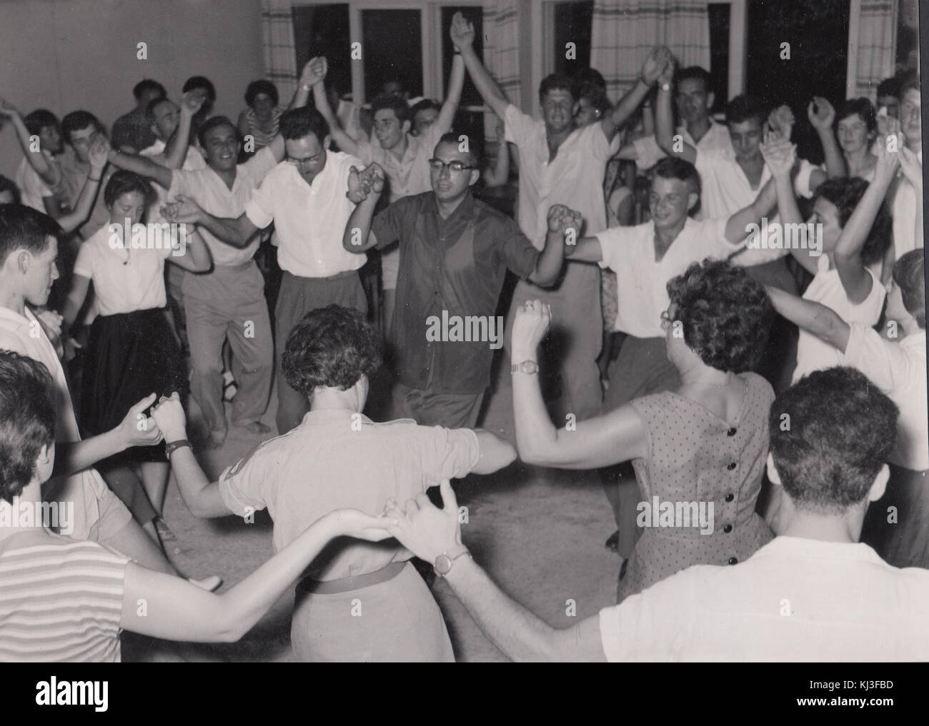 This image shows a group of individuals performing the Hora dance, a ...