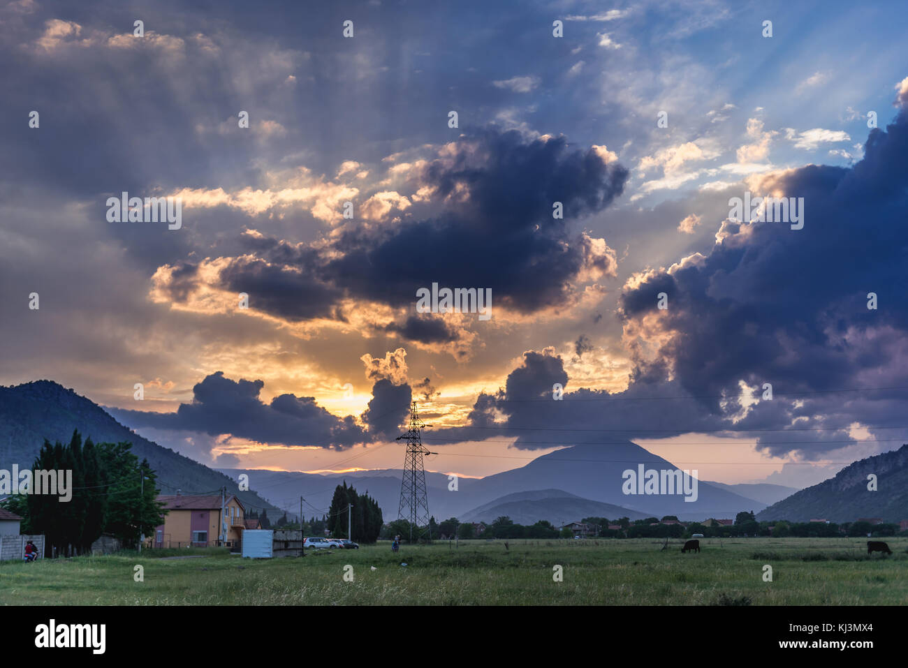 Sunset above mountains seen from outskirts of Podgorica, capital city ...