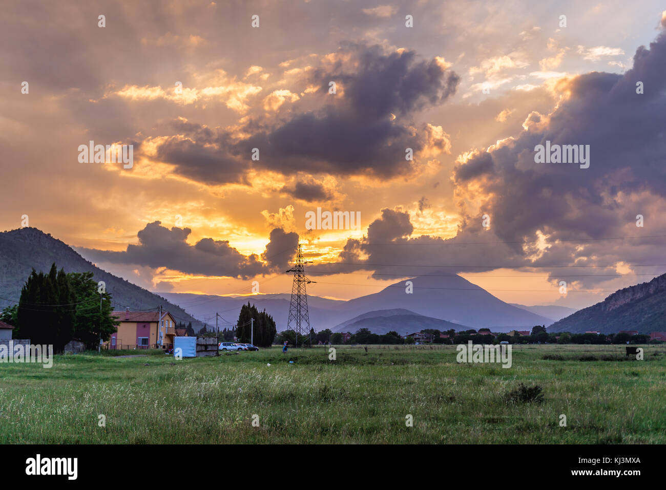 Sunset above mountains seen from outskirts of Podgorica, capital city ...