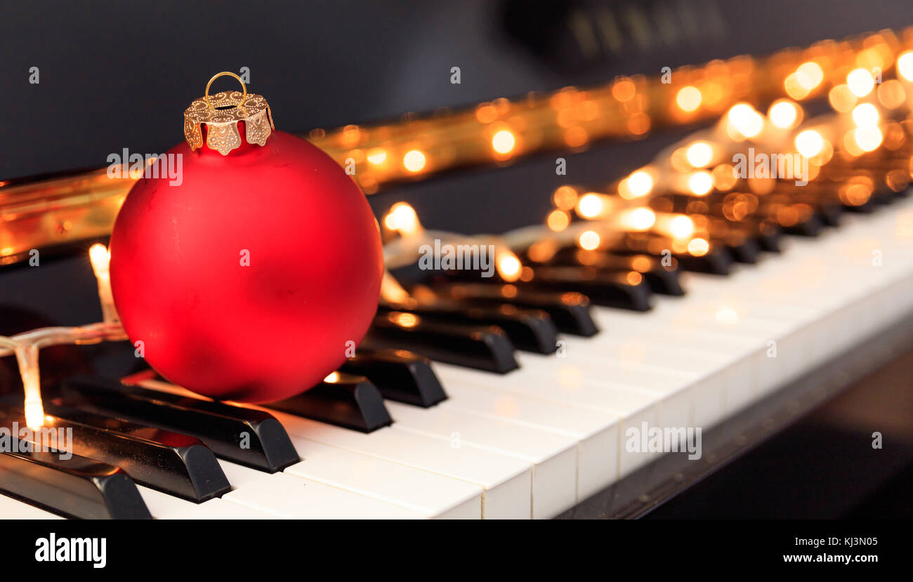 Christmas ball and lights on a classical piano keyboard Stock Photo - Alamy