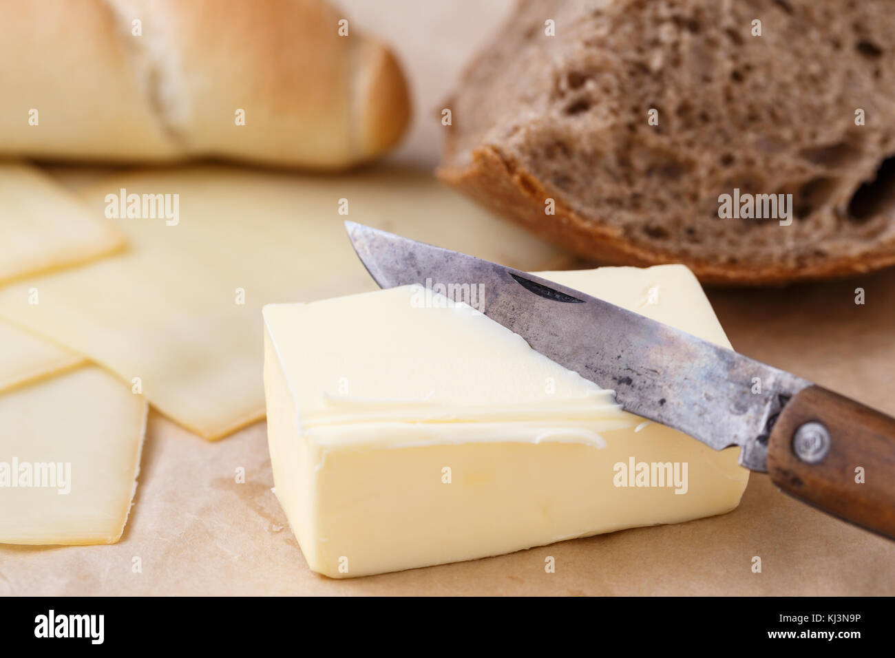 Butter and bread,cheese for breakfast,over rustic paper background ...
