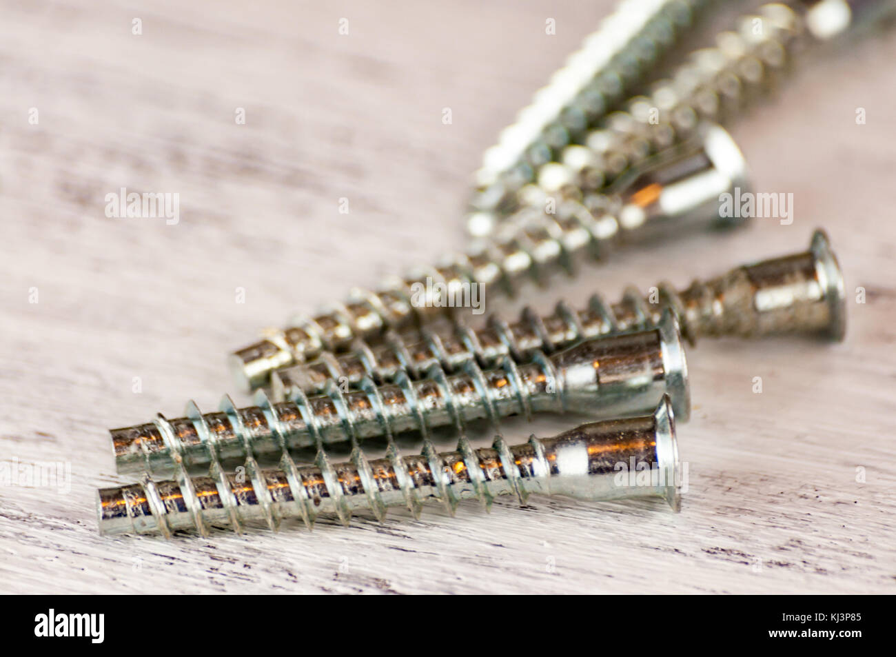 Several long screws lie on a light background. Macro photo Stock Photo ...